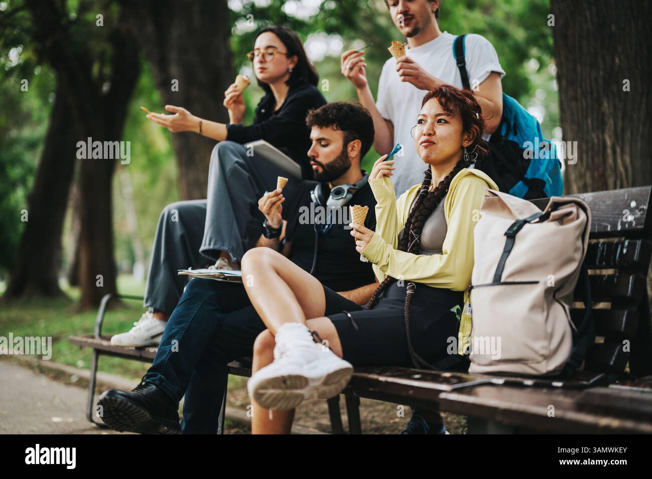 College students and professor enjoying ice cream break outside Stock ...