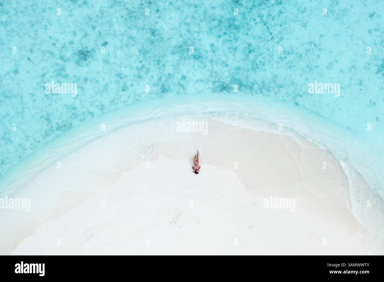 Aerial Top Down View Of Female Model Lying On White Sand Beach In South ...