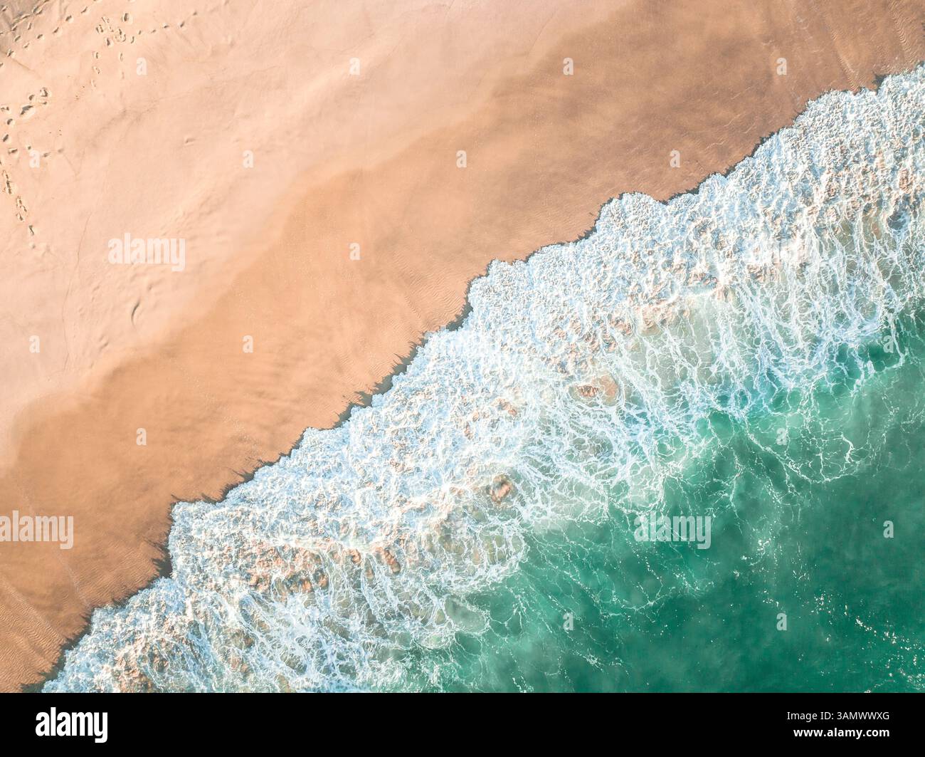 Aerial Top Down View Of Blue Ocean Waves Breaking Onto Sand At Bronte ...