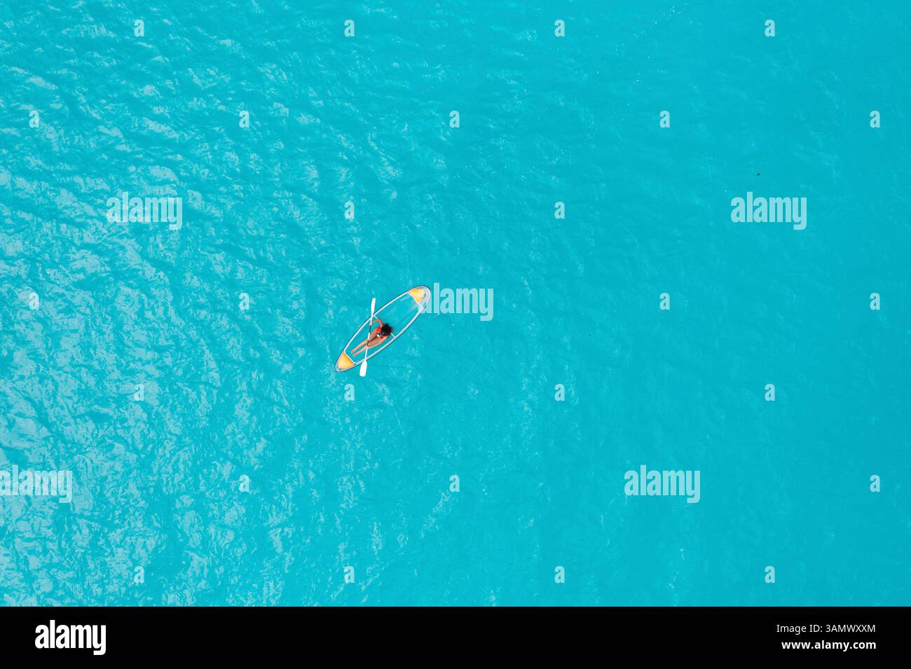 Aerial Top Down View Of Person Kayaking Over Clear Blue Ocean Water In ...