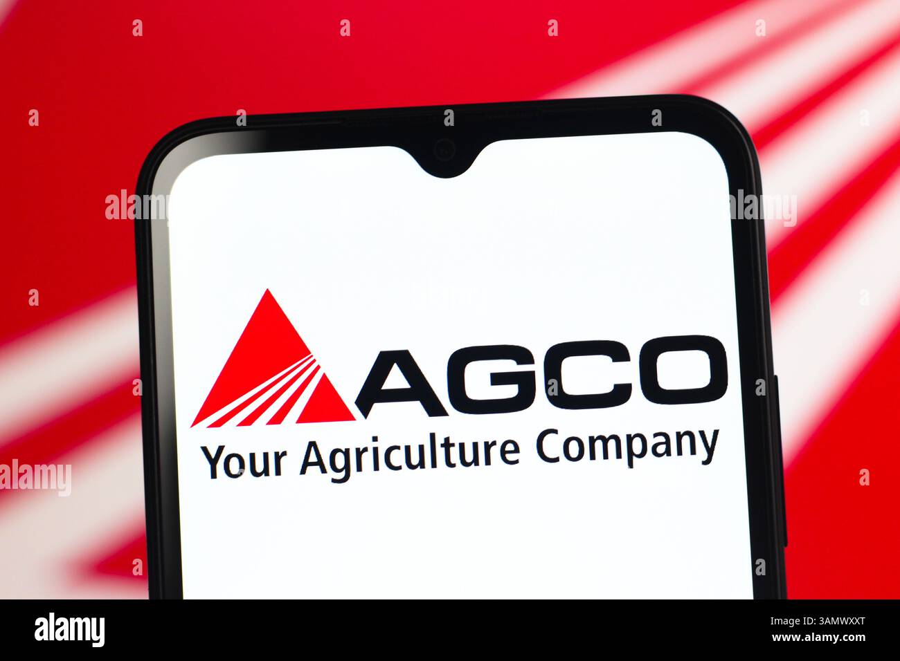 In this photo illustration, the AGCO Corporation logo is seen displayed ...