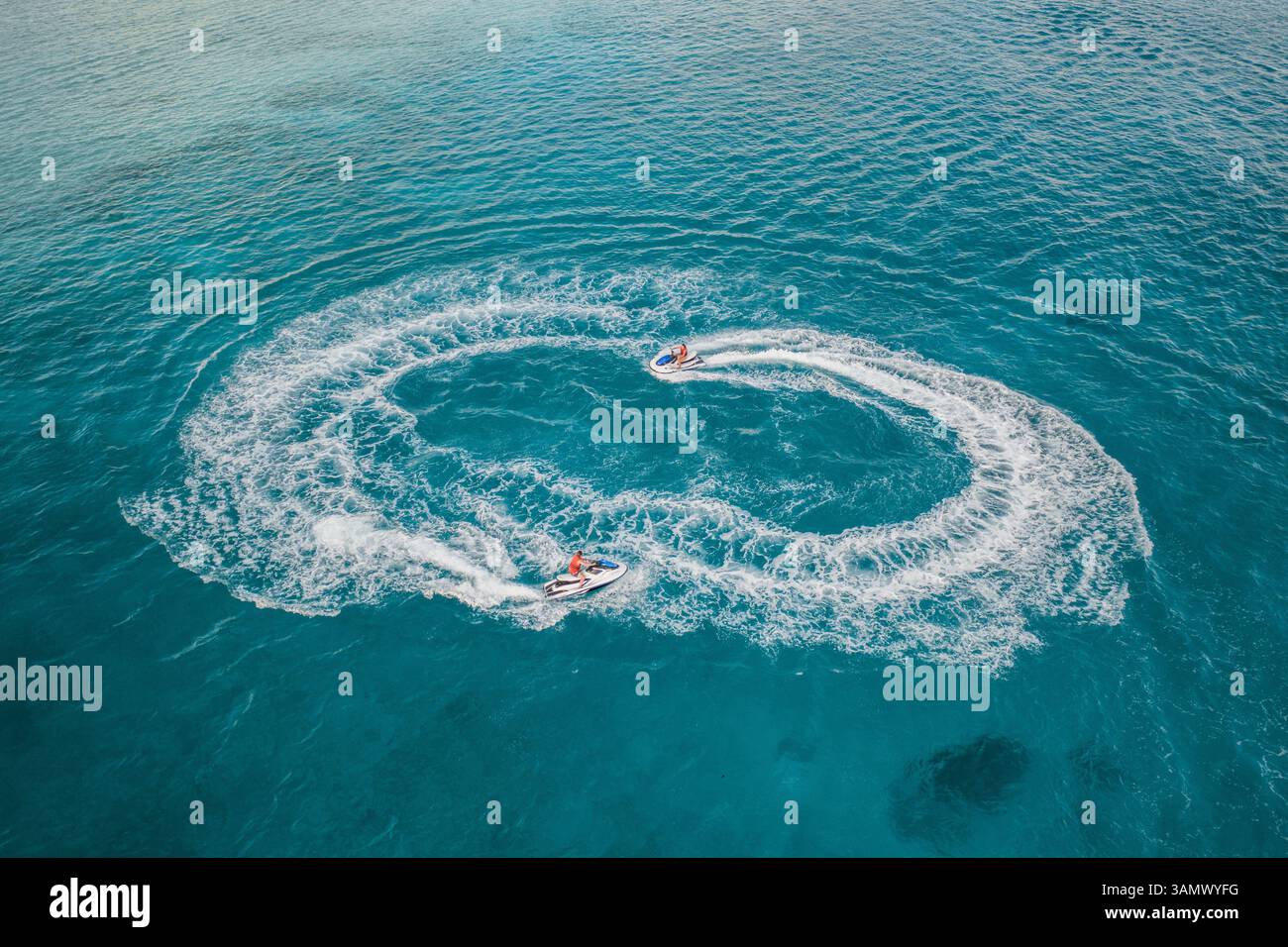 Aerial Top Down View Of People On Jet Skis Racing Around In Circle ...
