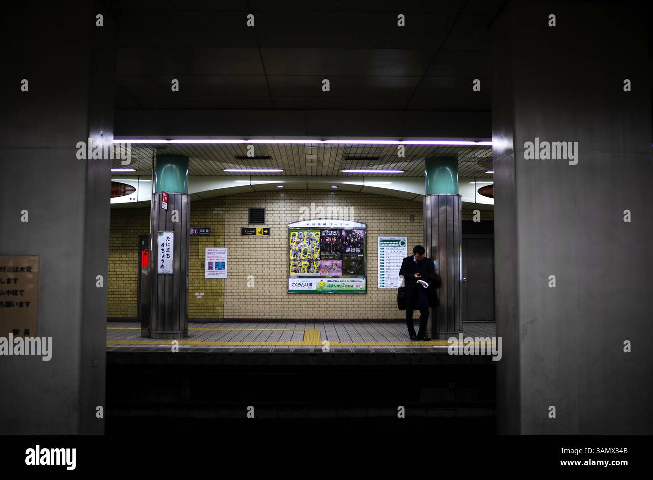 Dimly Lit Japanese Metro Station at Night - Solitary Business Commuter ...