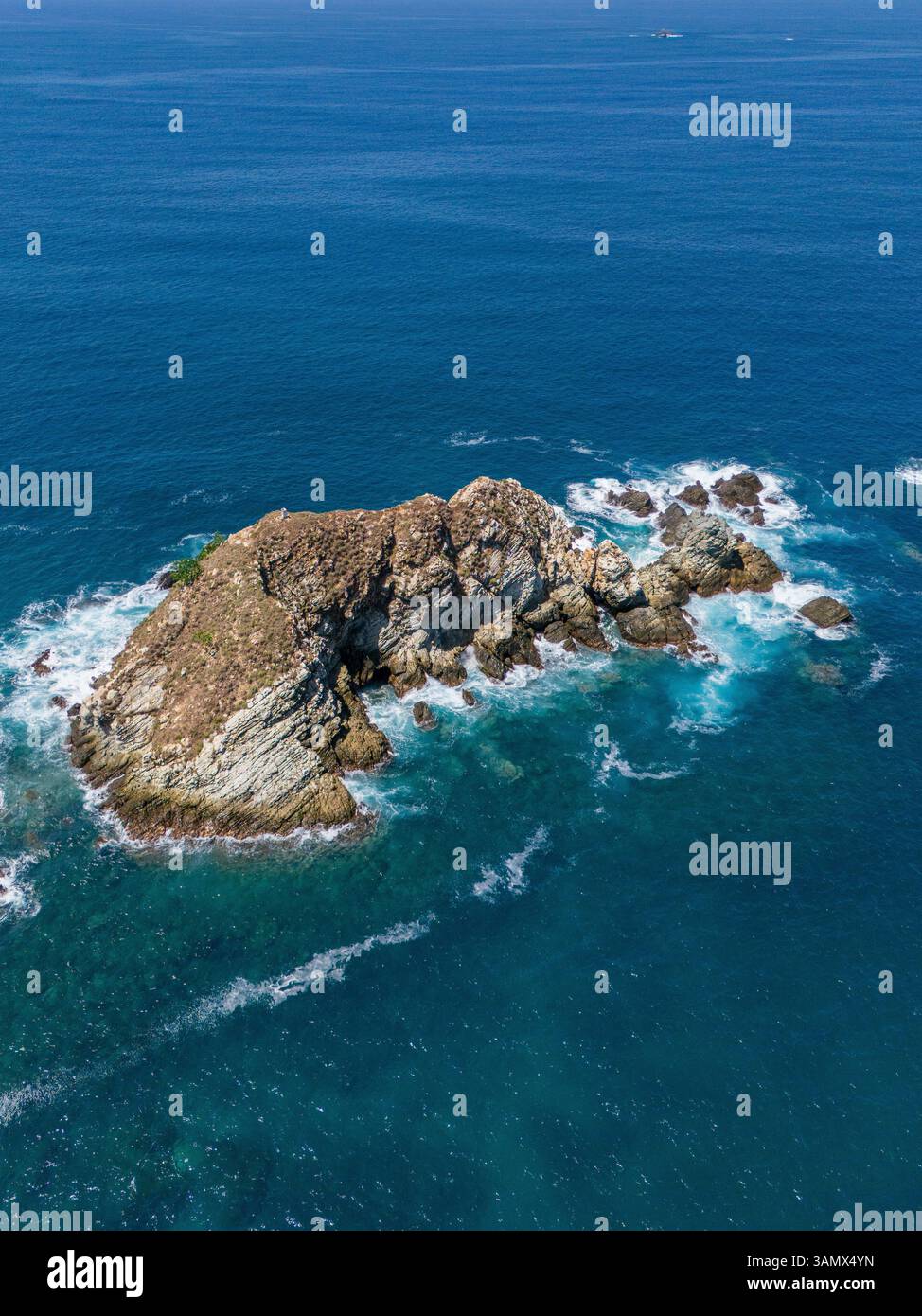 Aerial view of Ixtapa beach with a beautiful rock island and tranquil ...