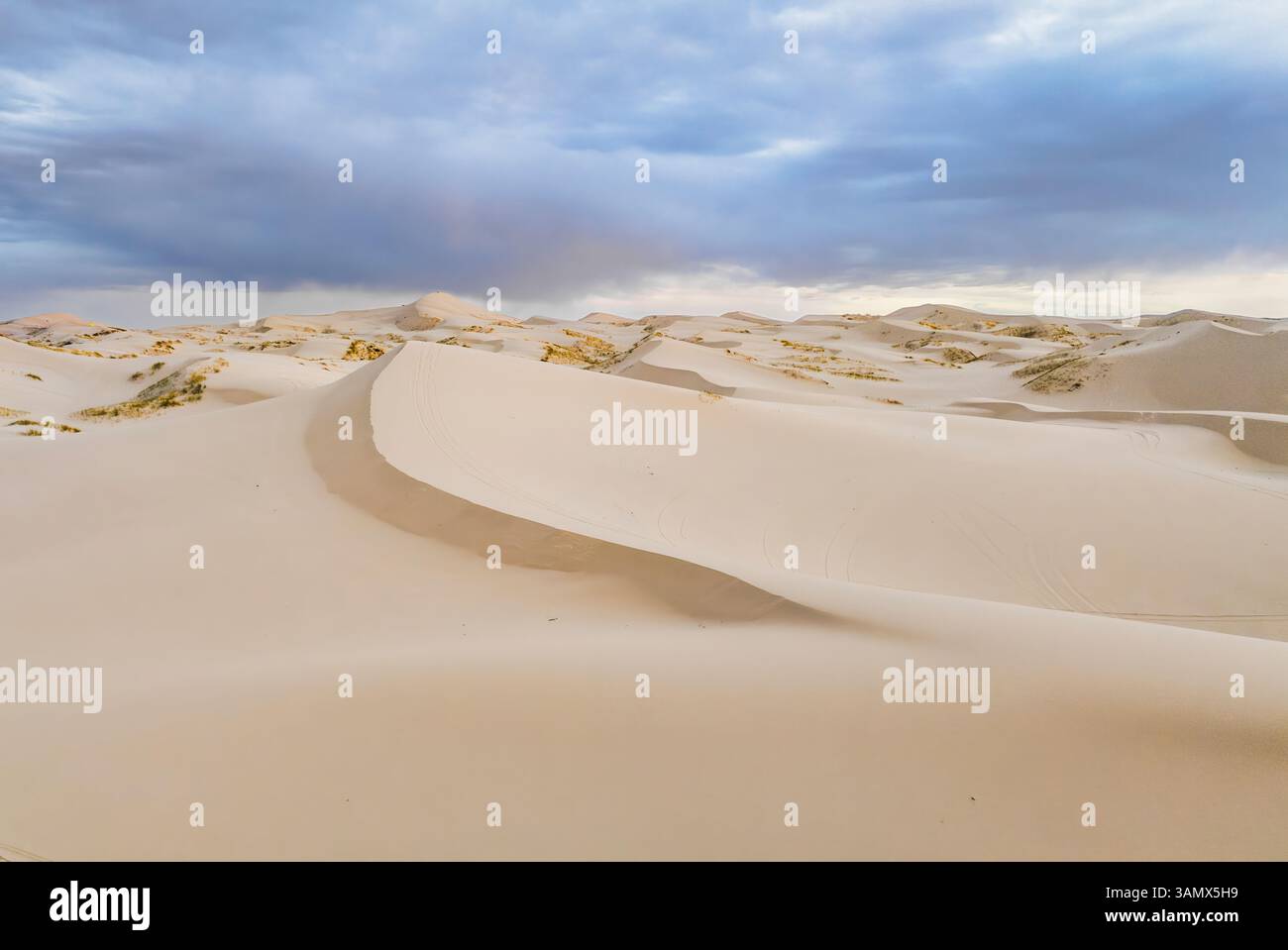 Aerial view of samalayuca dunes under a cloudy sky with expansive sand ...