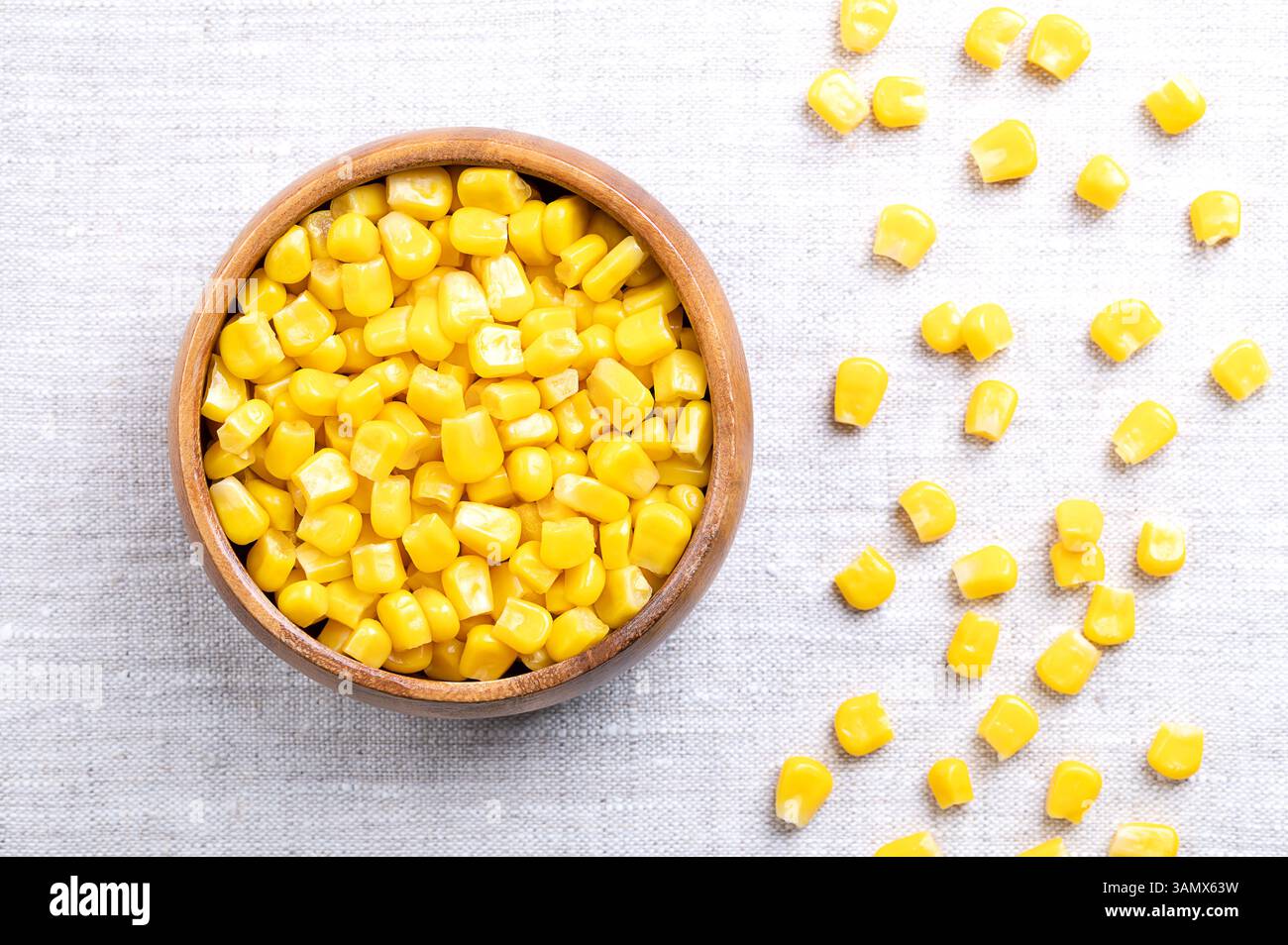 Canned vegetable maize, whole sweet corn kernels in a wooden bowl on ...