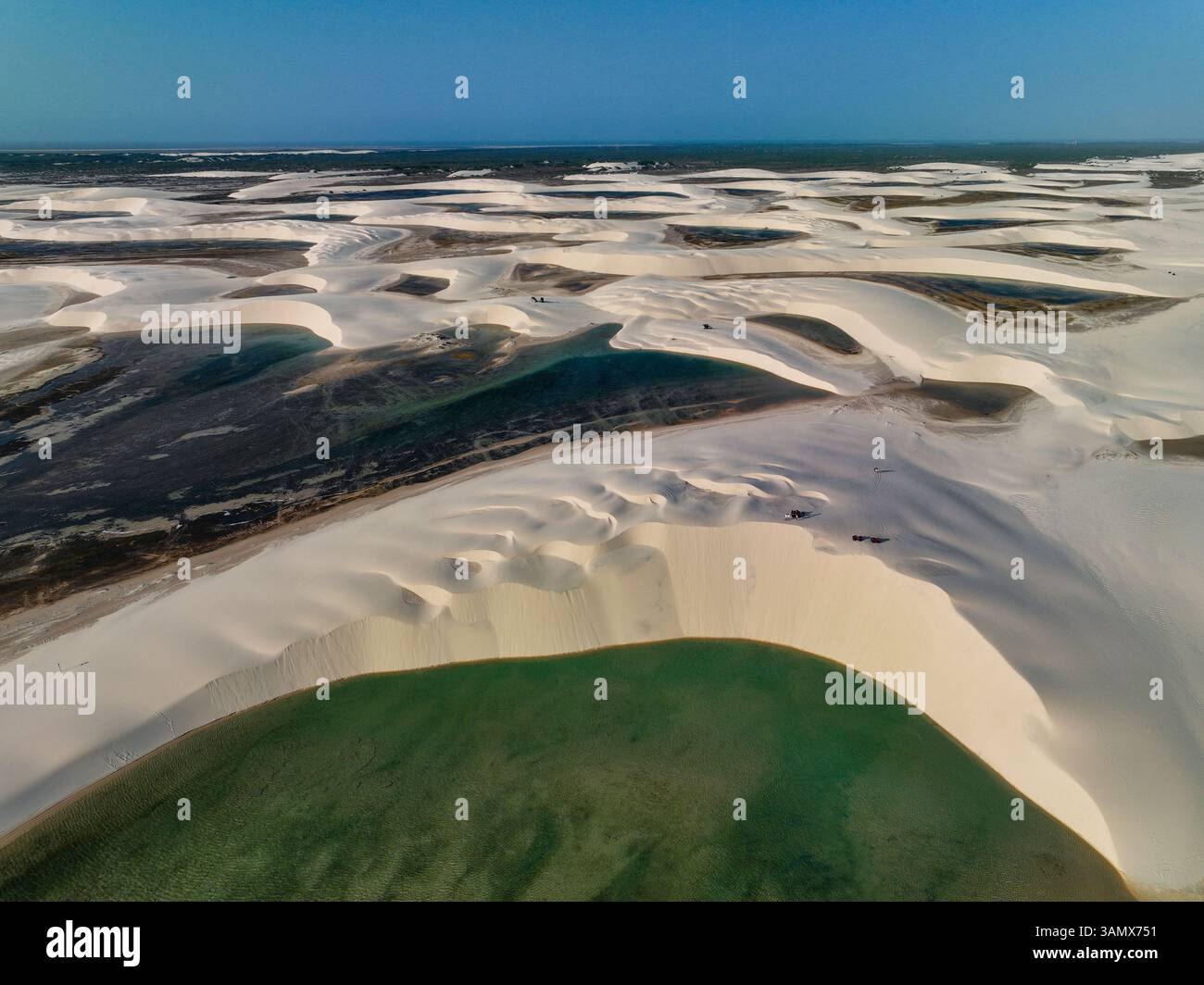 Aerial view of beautiful sand dunes and tranquil lagoons under a blue ...