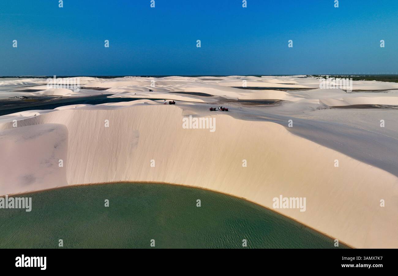 Aerial view of expansive sand dunes and serene lagoons under a clear ...