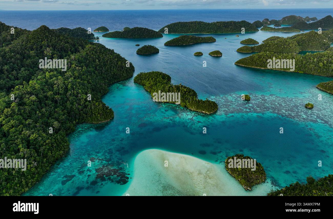 Aerial view of scattered islands with blue ocean water at Wajag Island ...