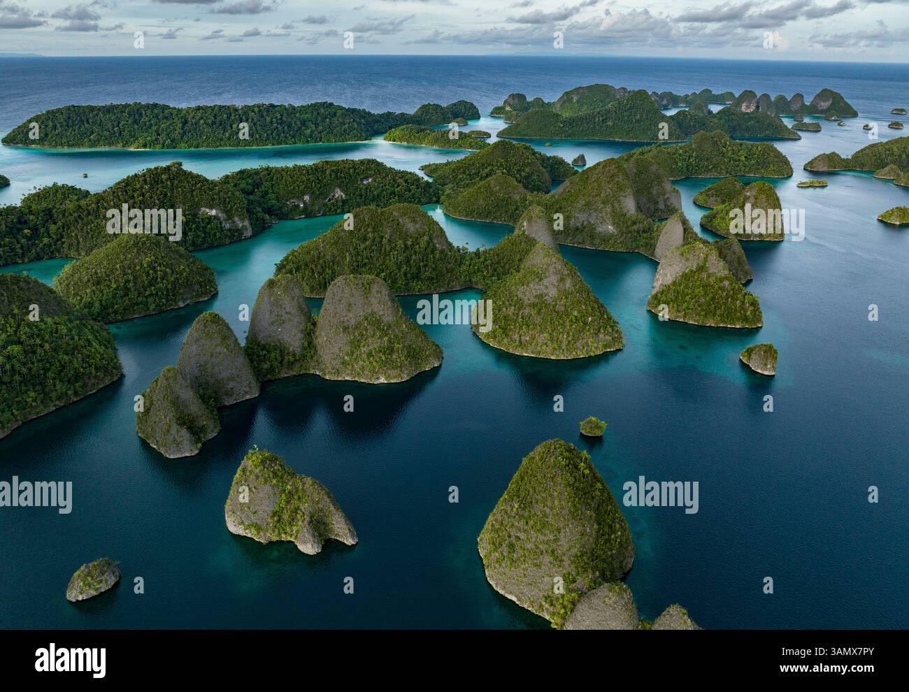 Aerial view of scattered islands with blue ocean water at Wajag Island ...