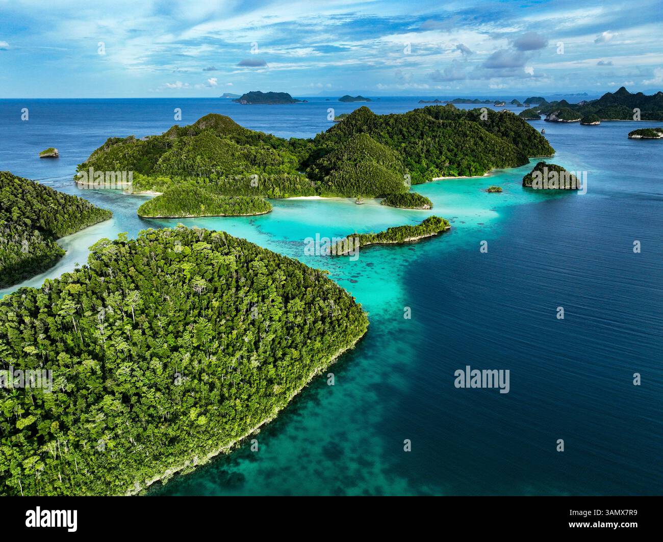 Aerial view of scattered islands with blue ocean water at Wajag Island ...