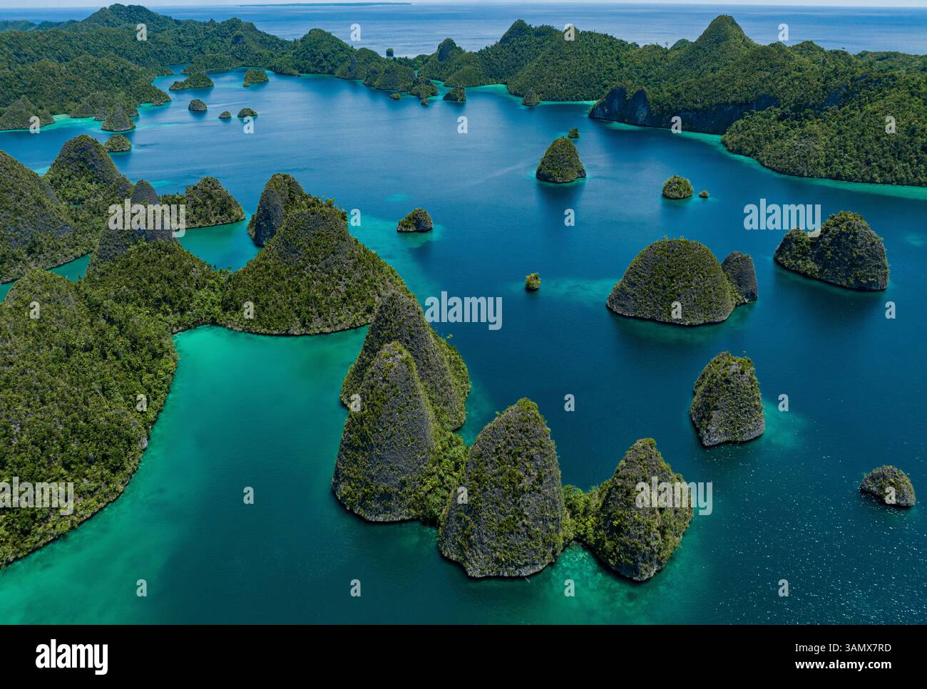 Aerial view of scattered islands with blue ocean water at Wajag Island ...