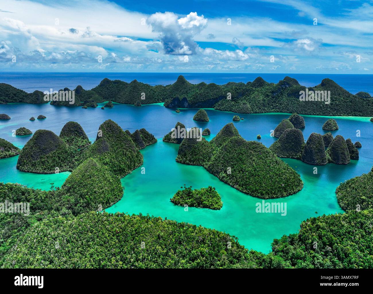 Aerial view of scattered islands with blue ocean water at Wajag Island ...