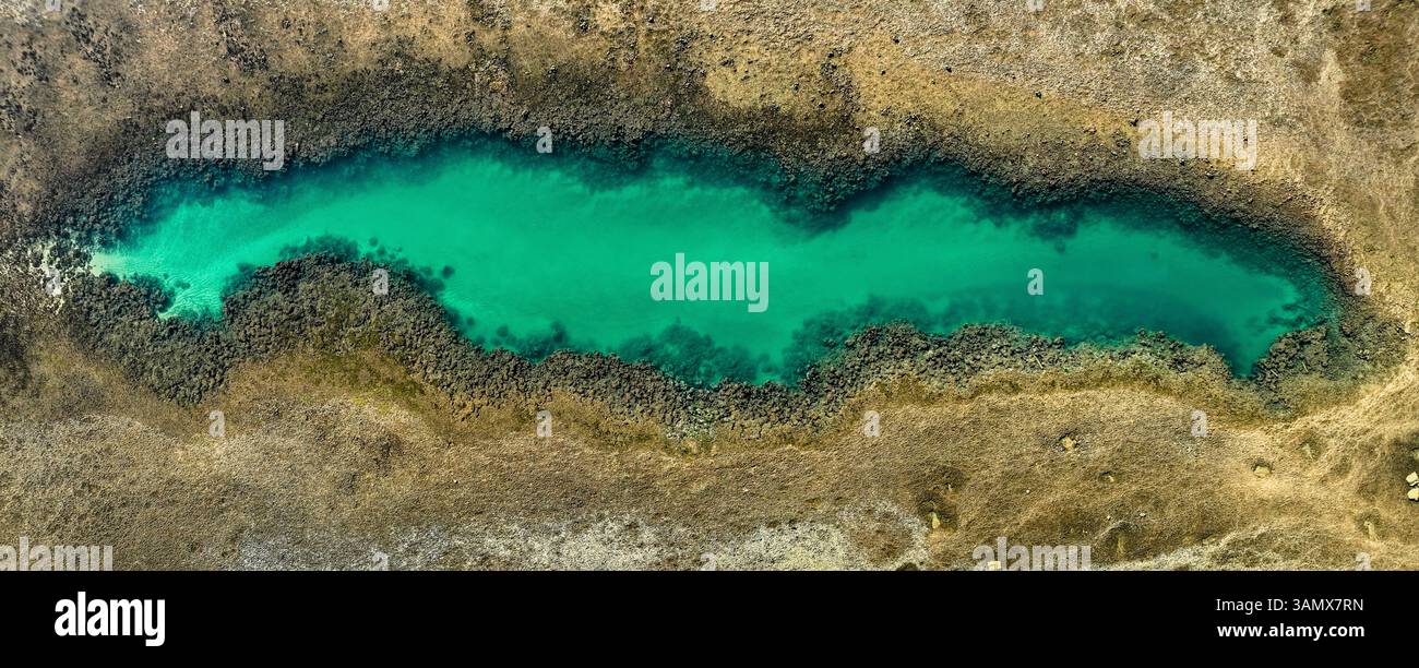 Aerial view of pristine turquoise lagoon and serene shoreline, Praia do ...