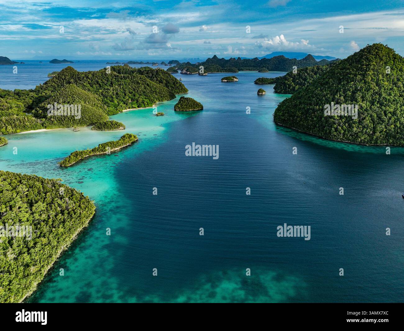 Aerial view of scattered islands with blue ocean water at Wajag Island ...