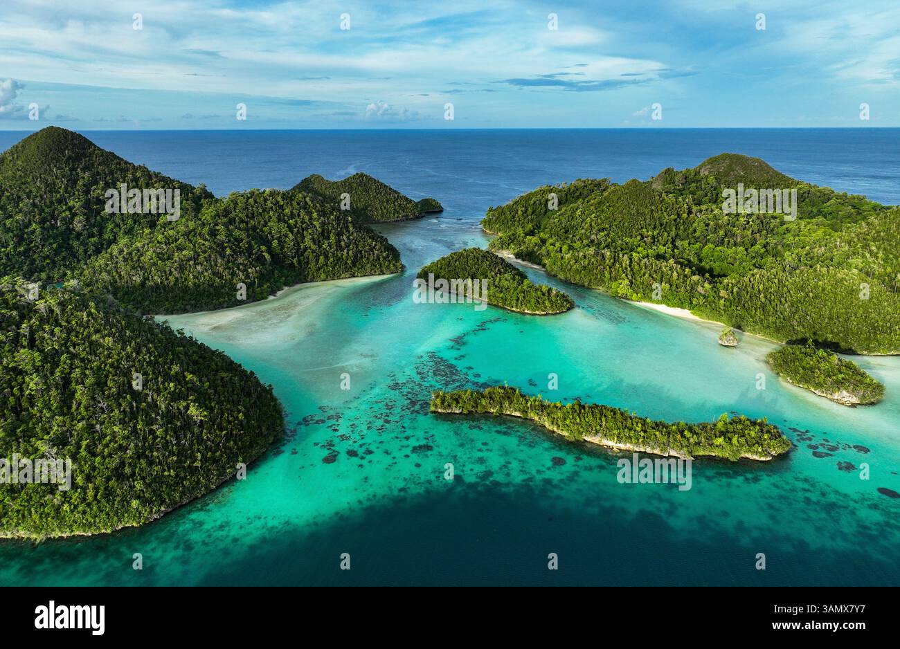 Aerial view of scattered islands with blue ocean water at Wajag Island ...