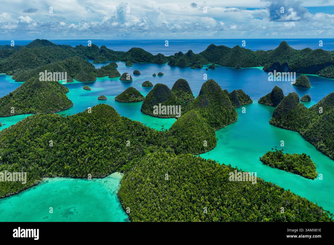 Aerial view of scattered islands with blue ocean water at Wajag Island ...