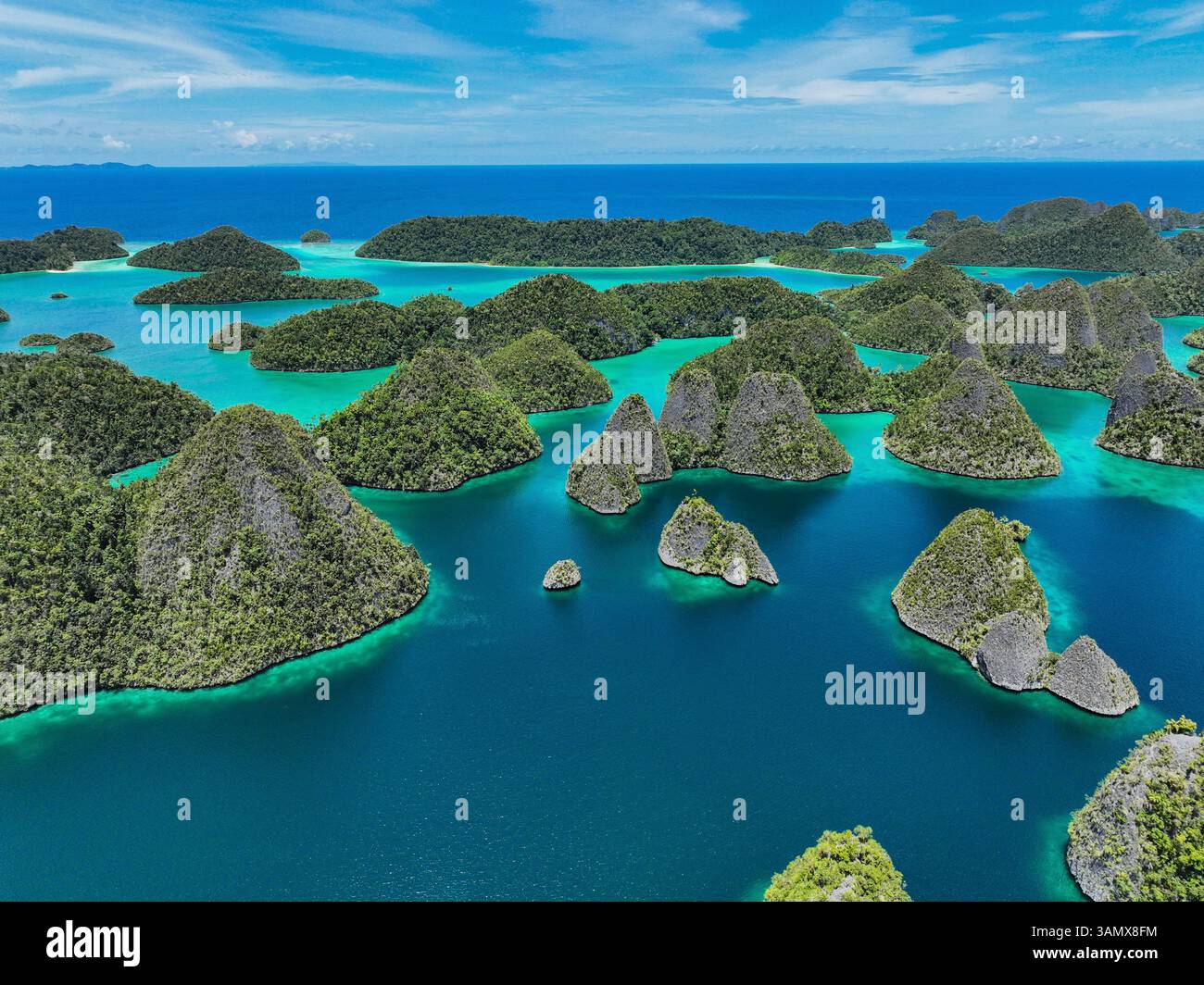 Aerial view of scattered islands with blue ocean water at Wajag Island ...