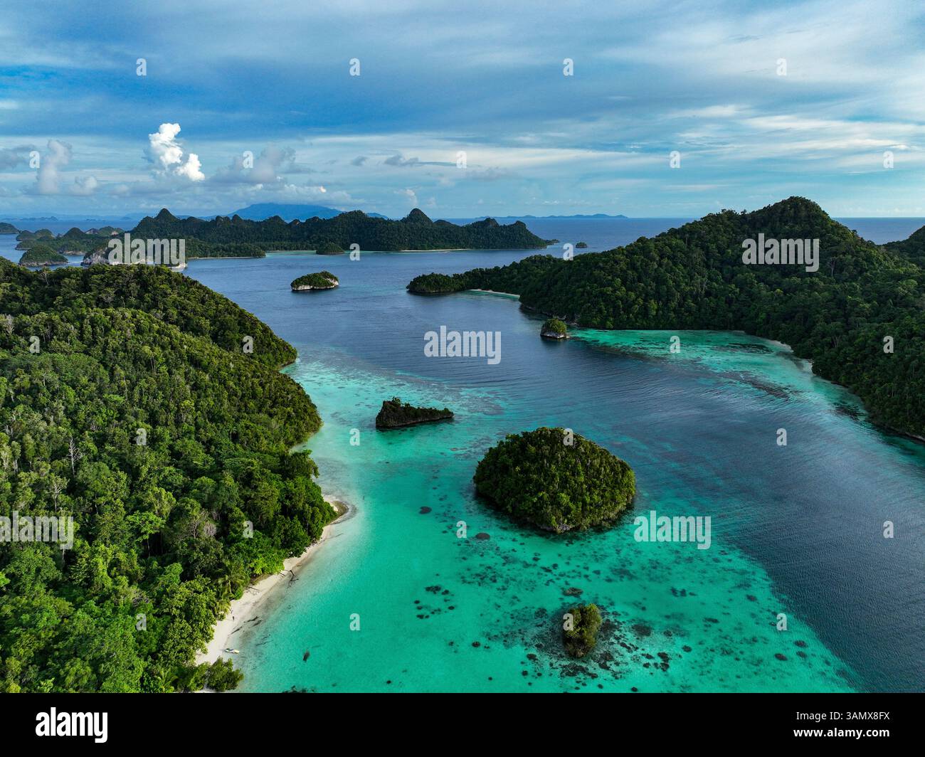 Aerial view of scattered islands with blue ocean water at Wajag Island ...