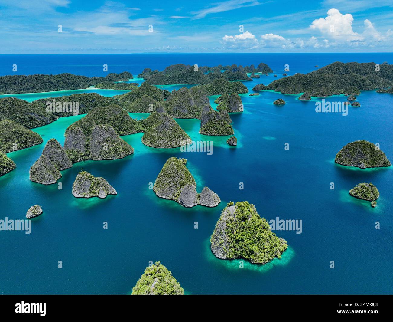 Aerial view of scattered islands with blue ocean water at Wajag Island ...