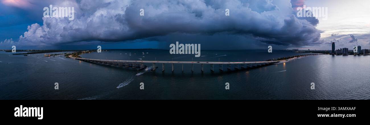 Aerial view of Rickenbacker Causeway with dramatic clouds and serene ...