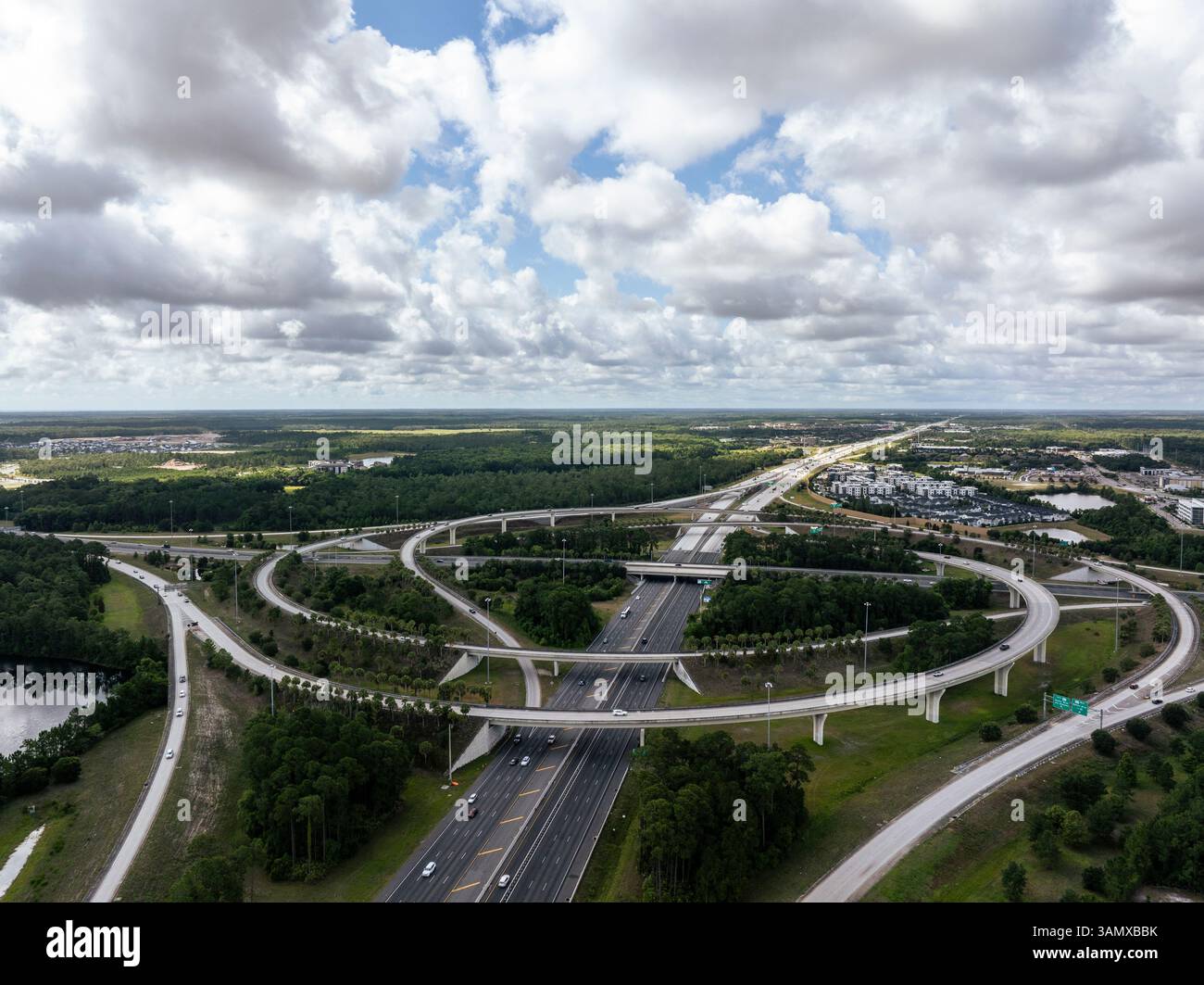 Aerial view of Turbine Interchange with highway, clouds, forest, and ...