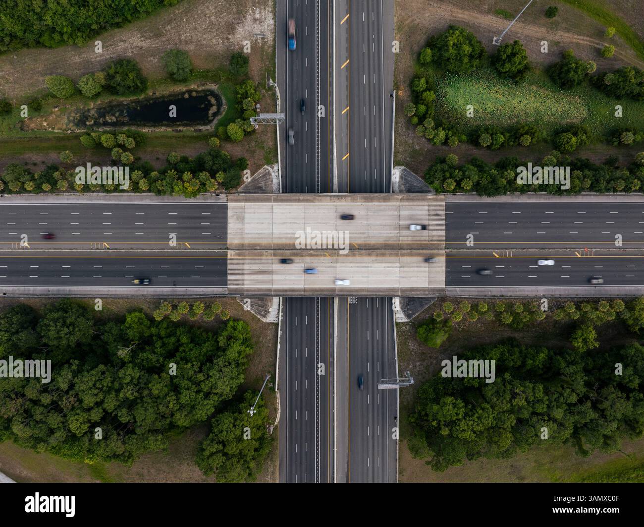 Aerial view of Turbine Interchange with highway, bridge, cars, trees ...