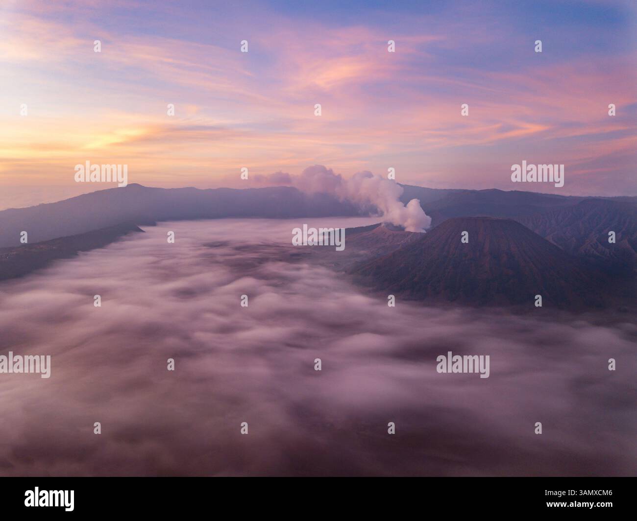 Aerial view of active smoking volcano Bromo (left) with Mount Batok ...