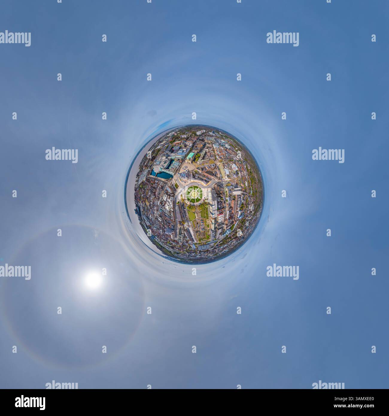 Aerial view of a tiny planet cityscape under a beautiful sky with sun ...