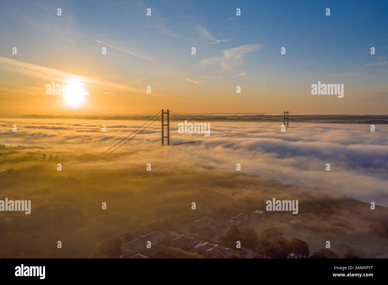 Aerial view of the Humber bridge at sunset covered with fog in Hull ...