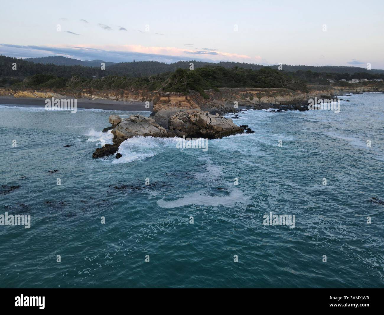 Aerial view of rugged coastline with dramatic rock formations and ...
