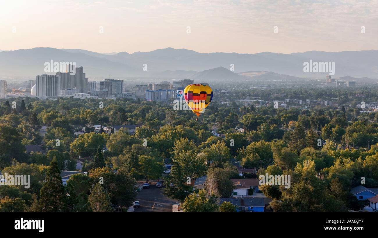 Aerial view of colorful hot air balloons over a scenic cityscape with ...