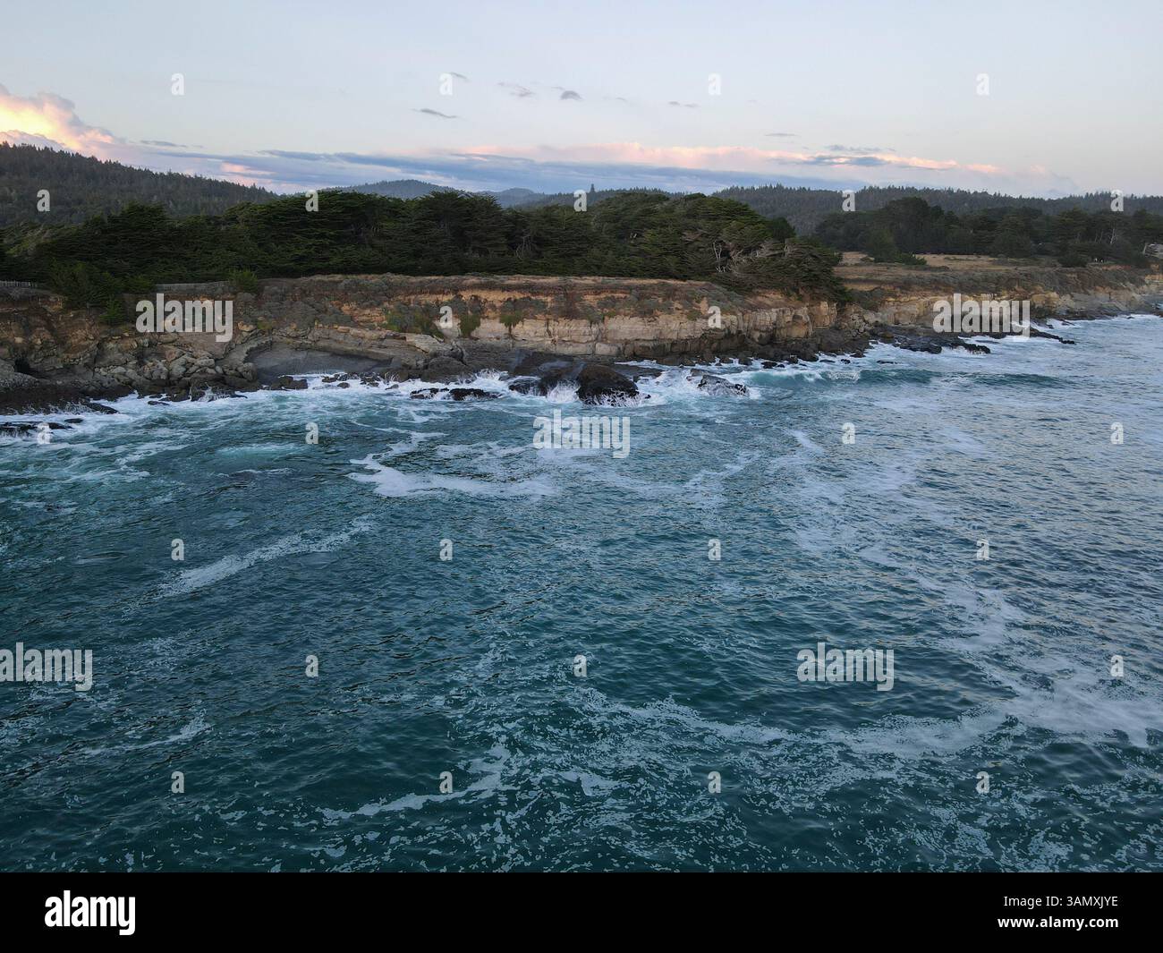 Aerial view of serene and picturesque rocky coastline with blue ocean ...