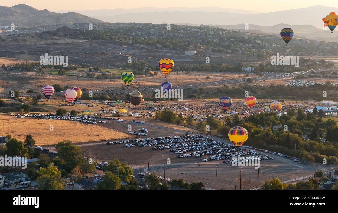 Aerial view of colorful hot air balloons over scenic landscape with ...