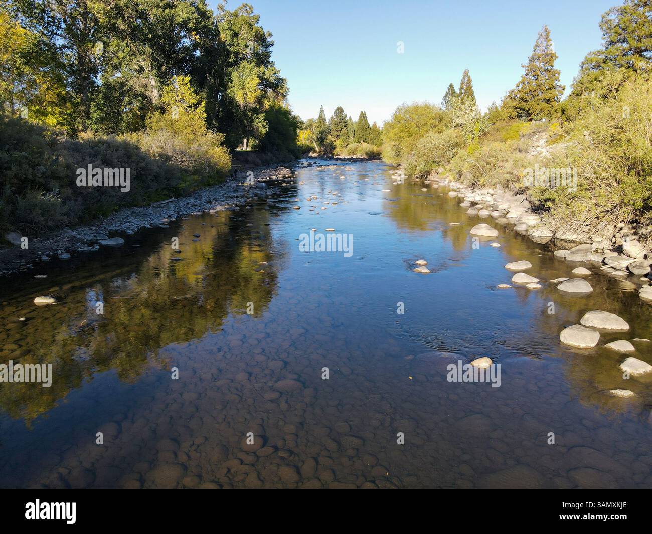 Aerial view of the serene Truckee River with clear water reflecting ...