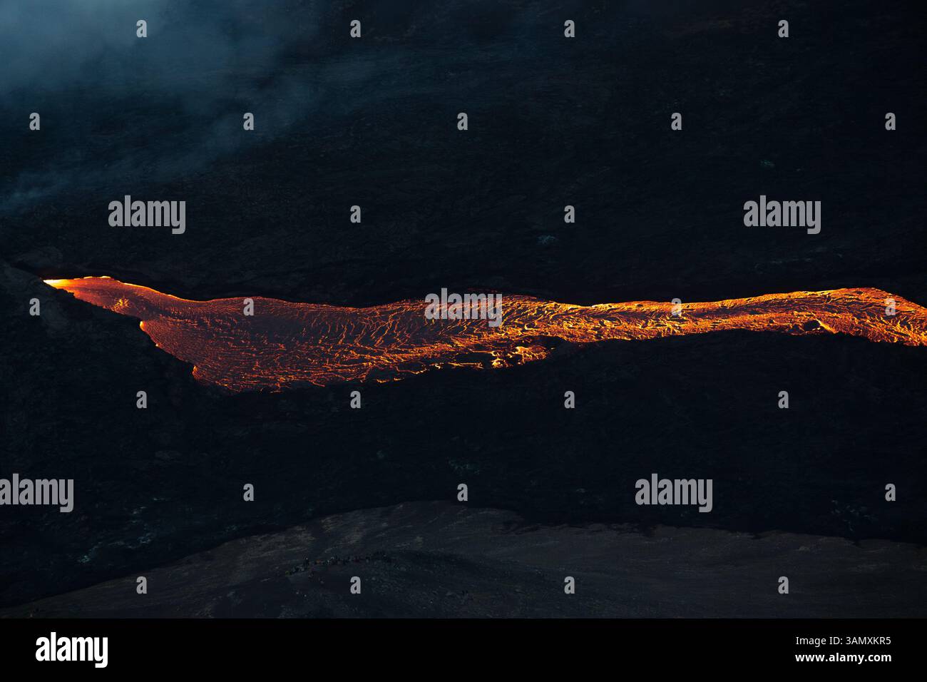 Aerial view of Litli Hrutur volcanic eruption with flowing lava ...