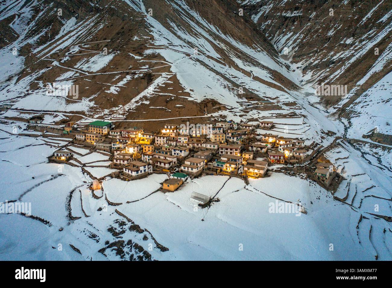Aerial view of snow-capped mountains and rustic village in winter, Mud ...