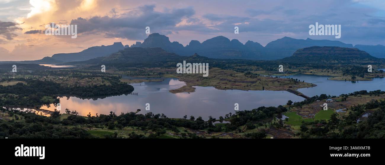 Aerial view of serene lake surrounded by majestic mountains and lush ...