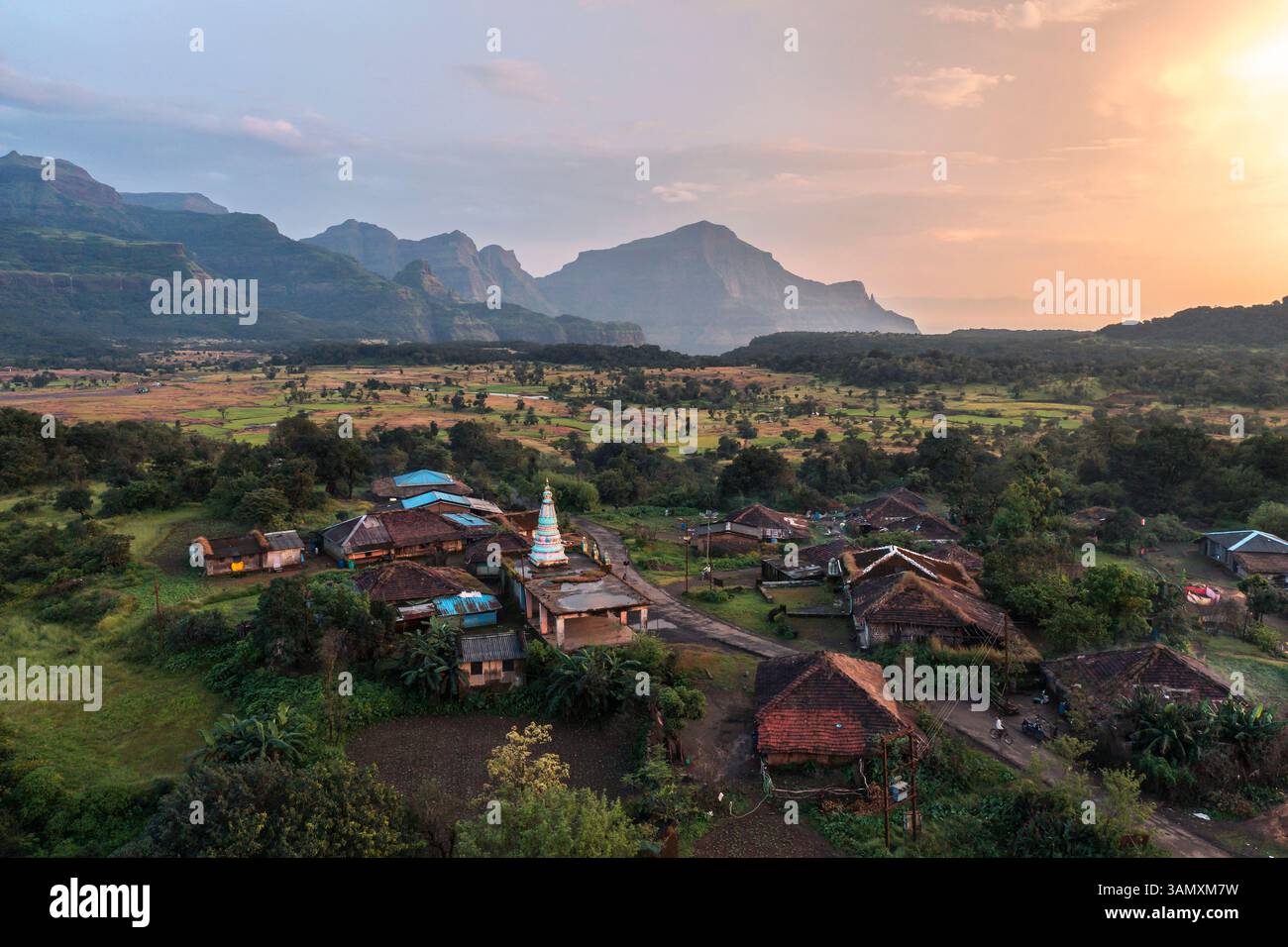 Aerial view of rustic village nestled among majestic mountains at ...