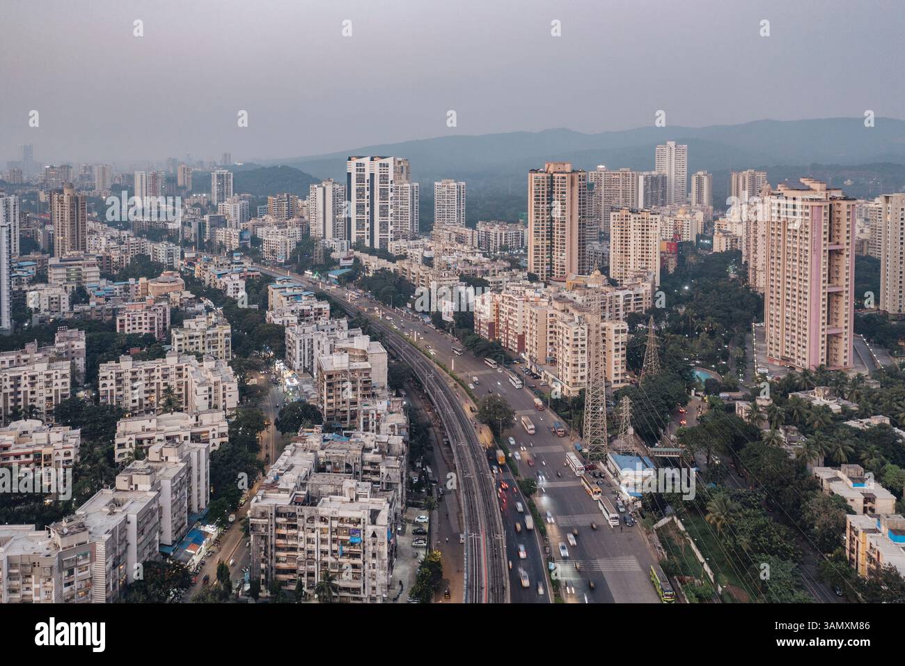 Aerial view of modern cityscape with dense buildings and greenery ...