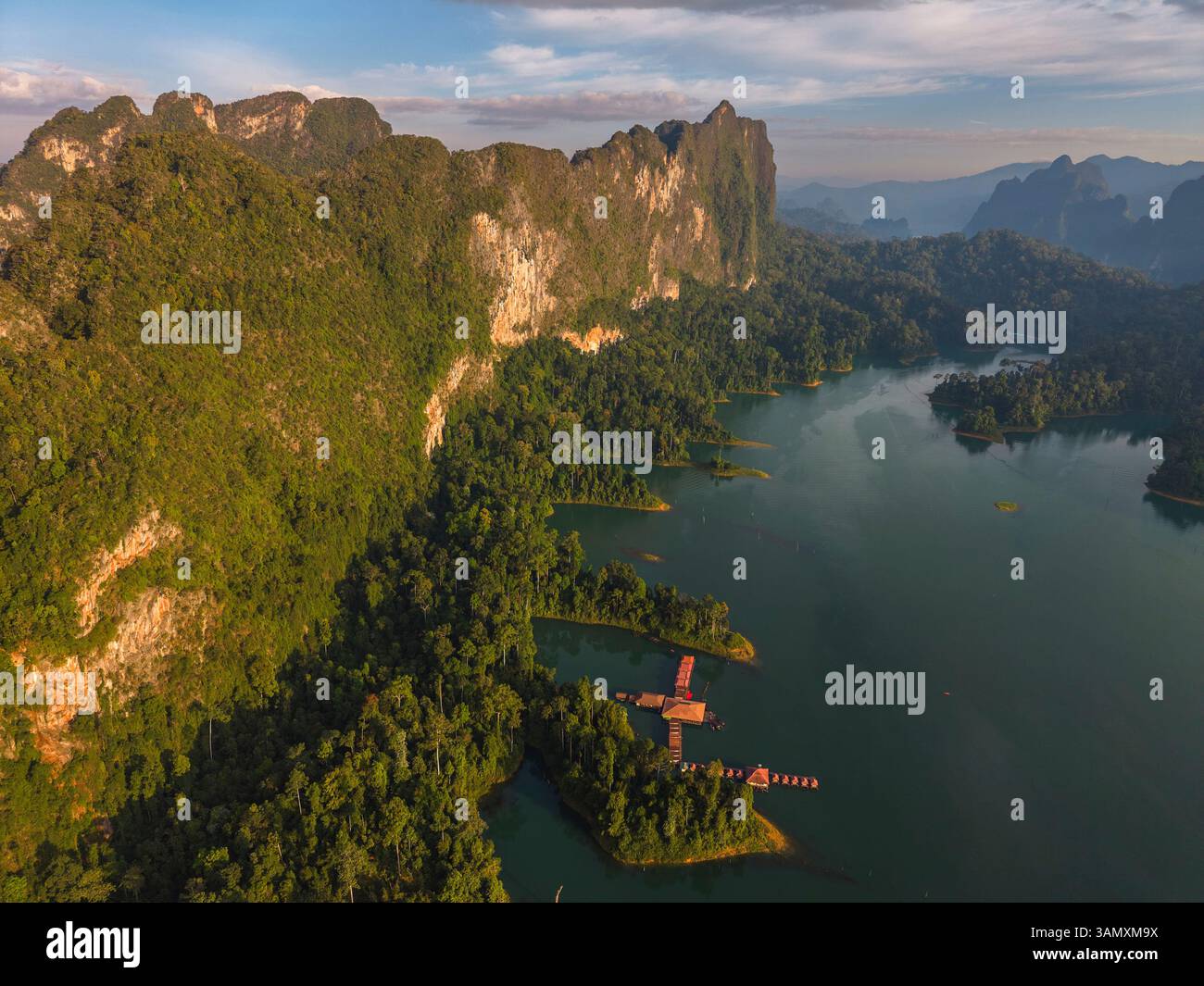 Aerial view of serene Cheow Larn Lake surrounded by lush rainforest and ...