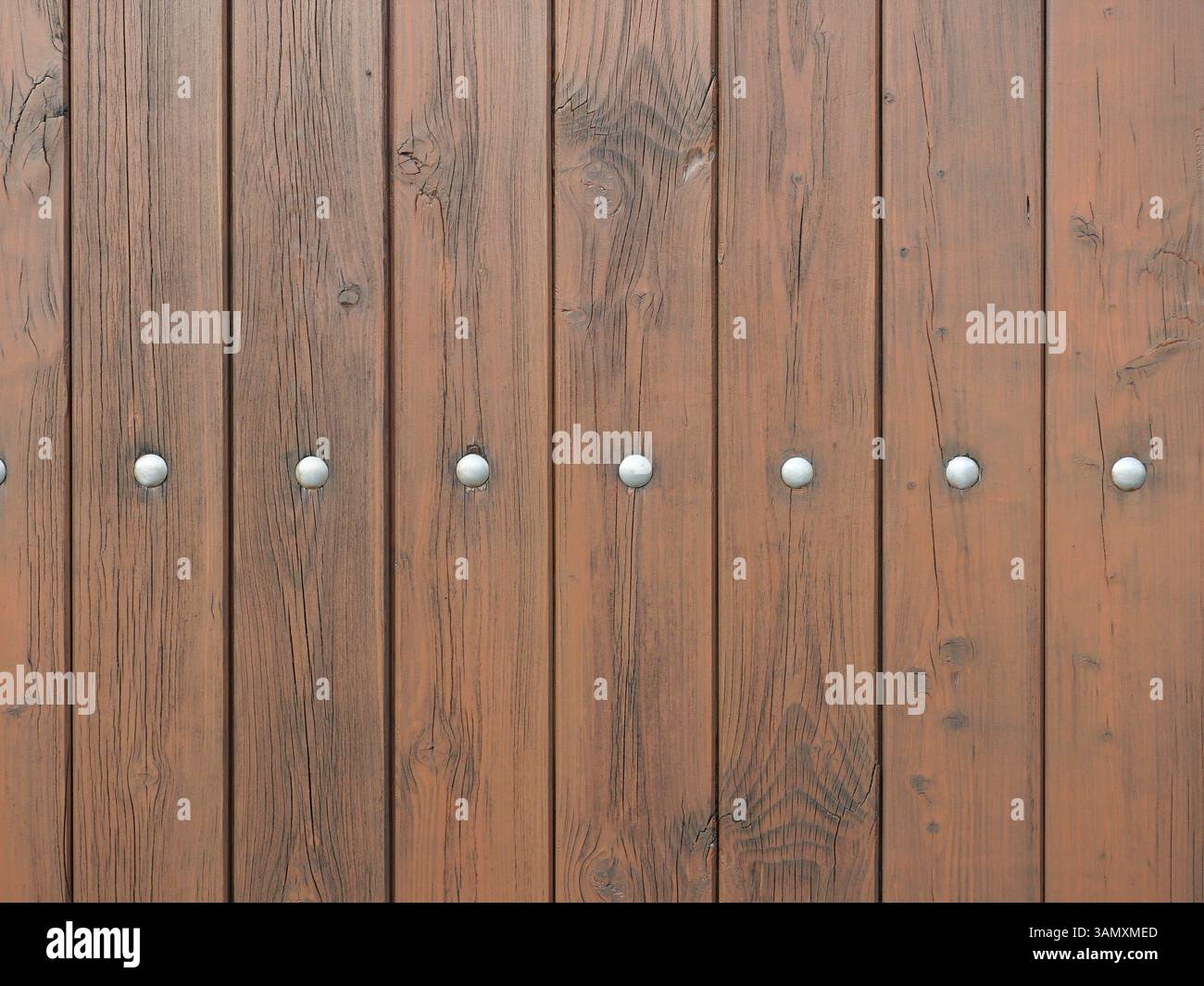 The wooden wall shows planed wood, the surface of which is heavily ...
