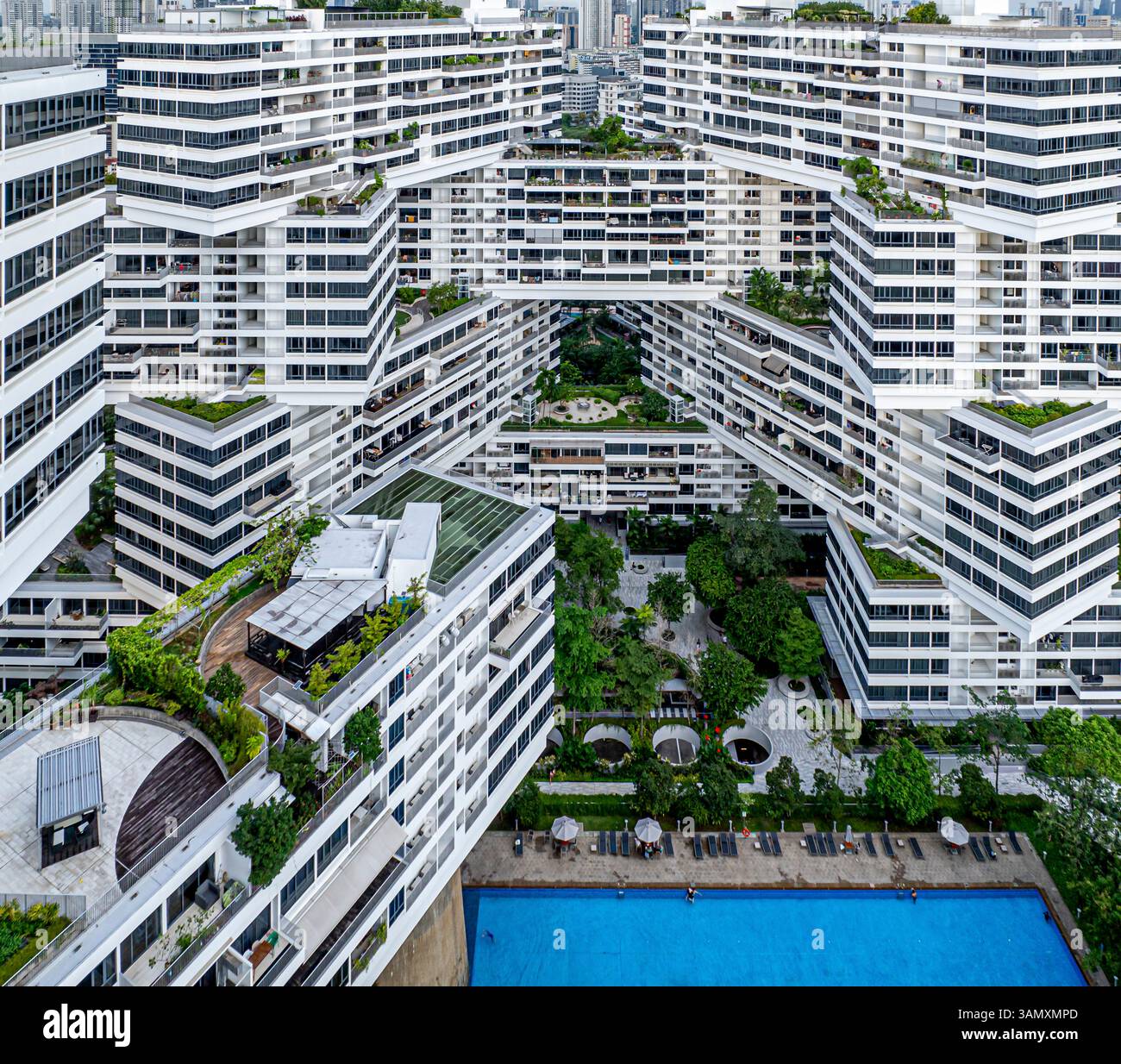 Aerial view of interlace condominium surrounded by lush greenery and ...