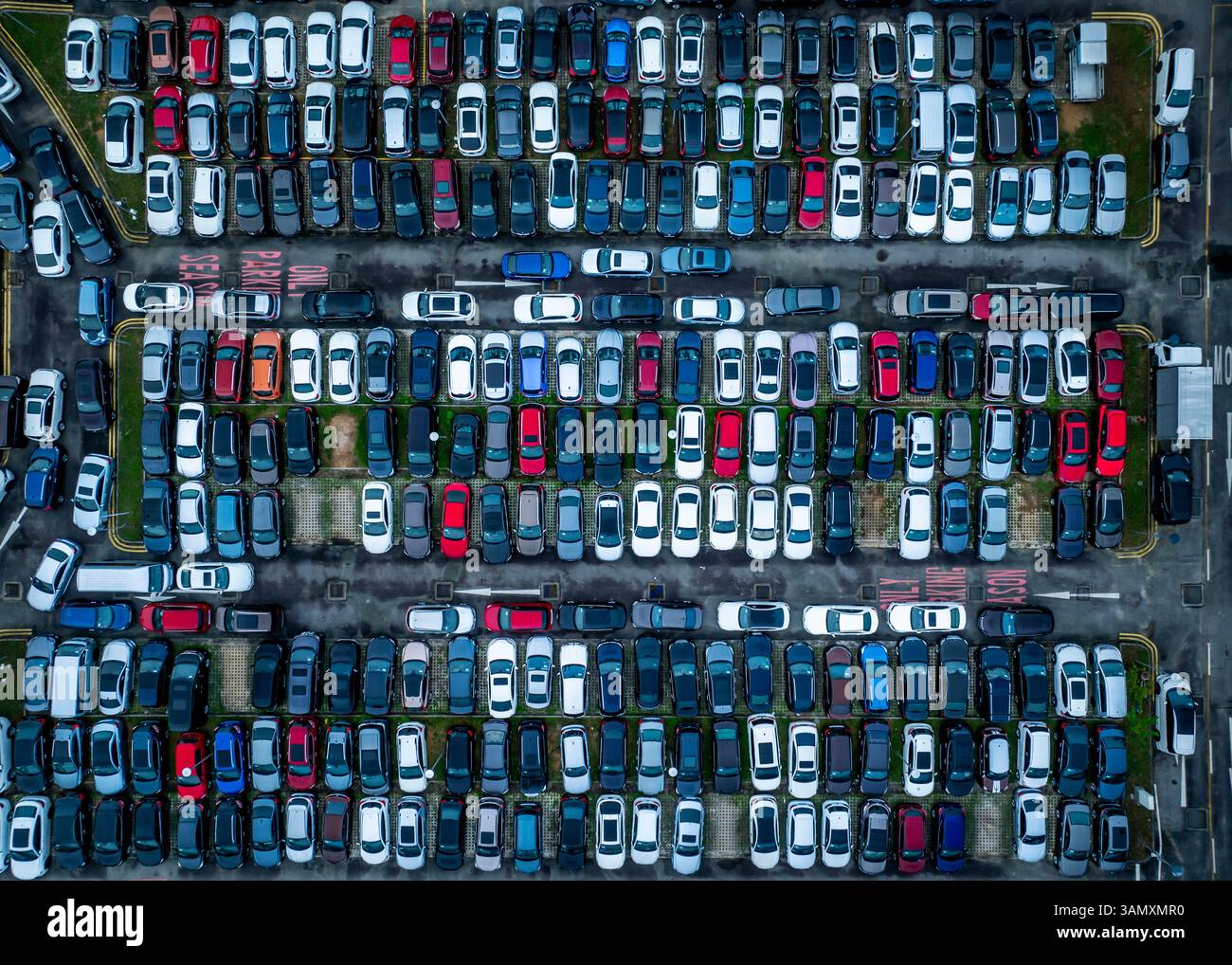 Aerial view of colorful rows of cars in a busy parking lot at Pasir ...