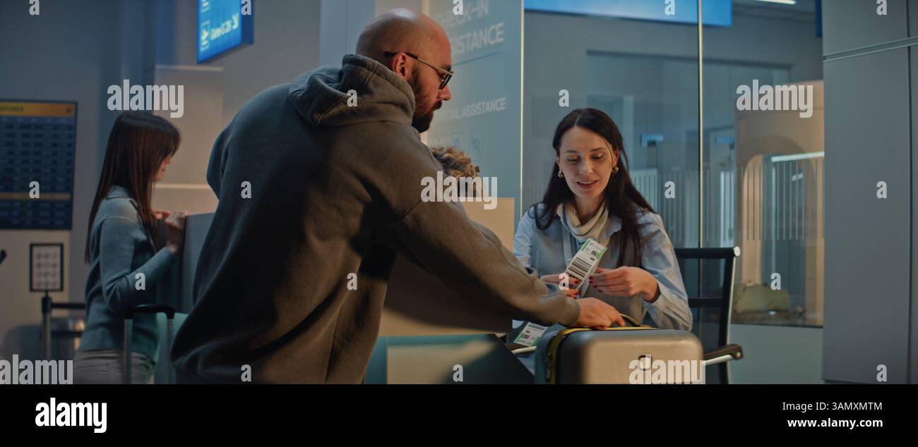 Airport Counter: Female Airline Check-in Attendant Putting Baggage Tag ...