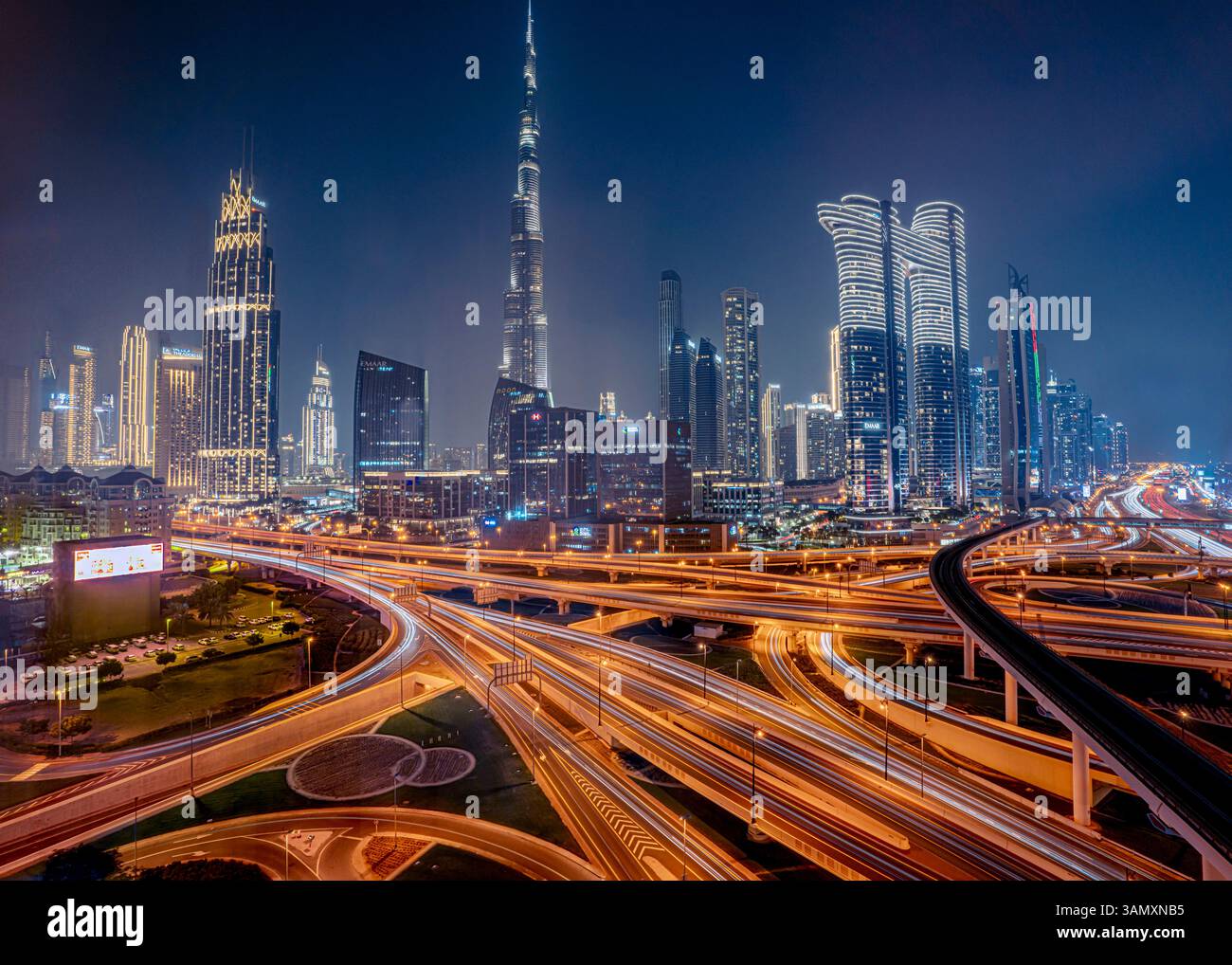 Aerial view of bustling Dubai nightlife with illuminated Burj Khalifa ...