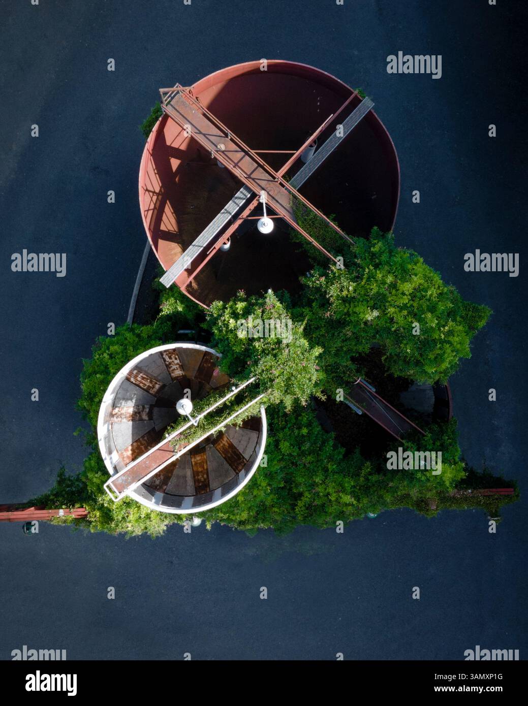 Aerial view of industrial structures surrounded by greenery and modern ...