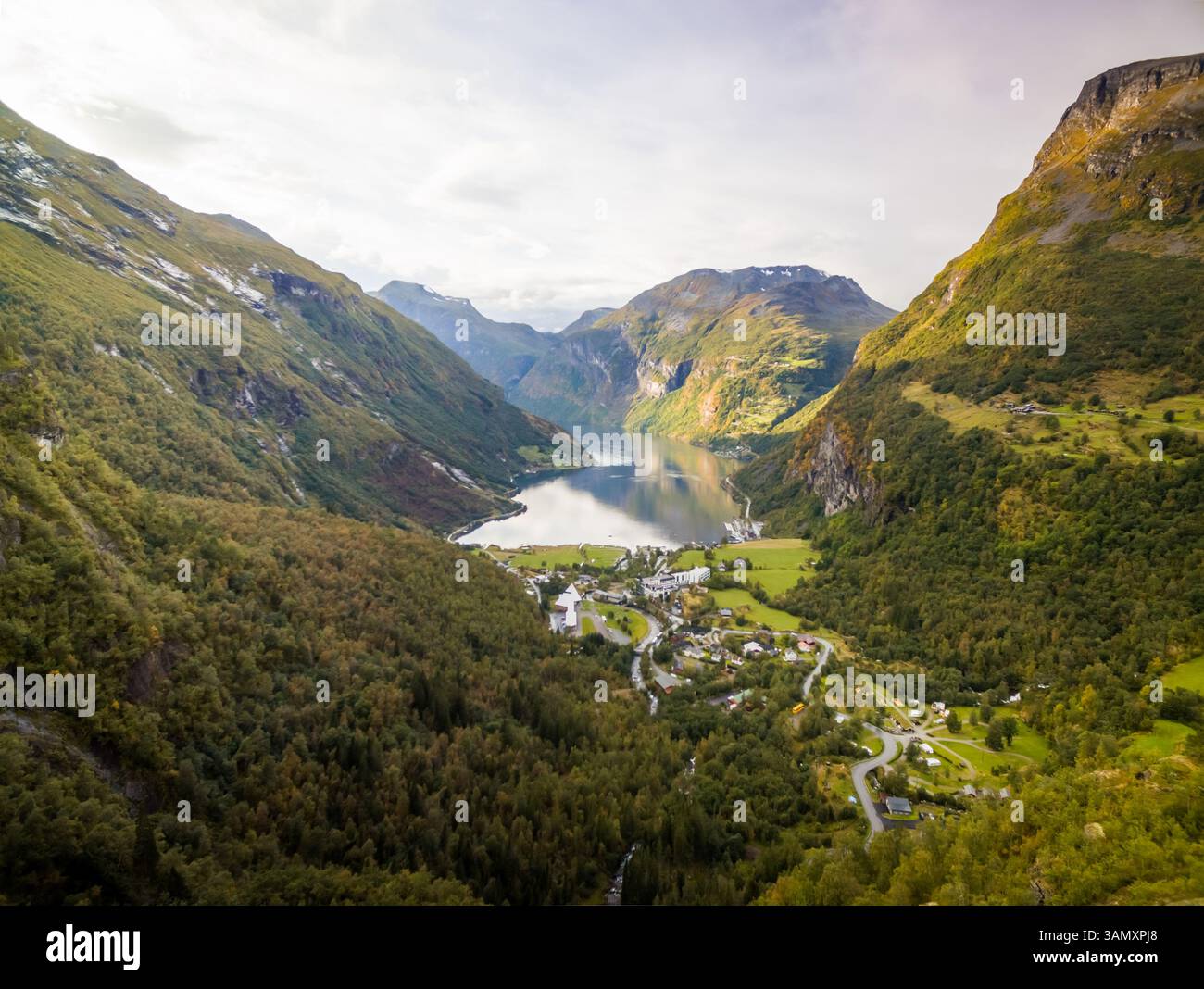 Aerial view of Geiranger village surrounding by tall mountains, Norway ...