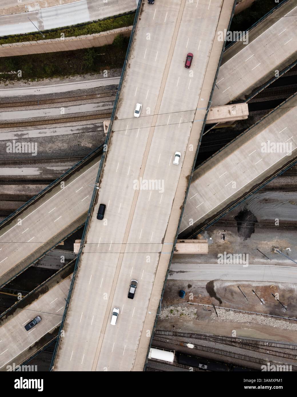 Aerial view of modern urban infrastructure with winding highways and ...