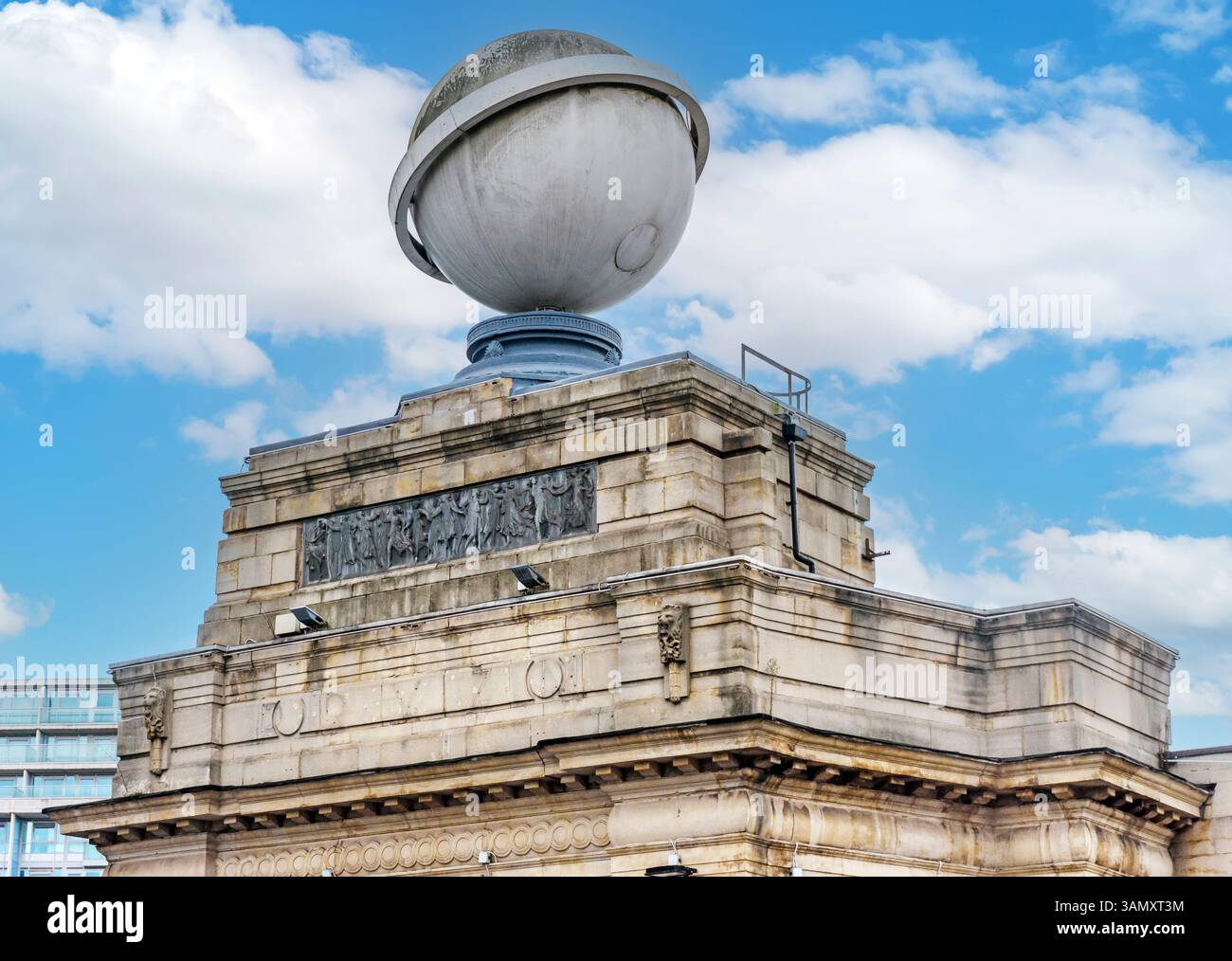 The globe and frieze of dancers above the entrance of the Palais ...